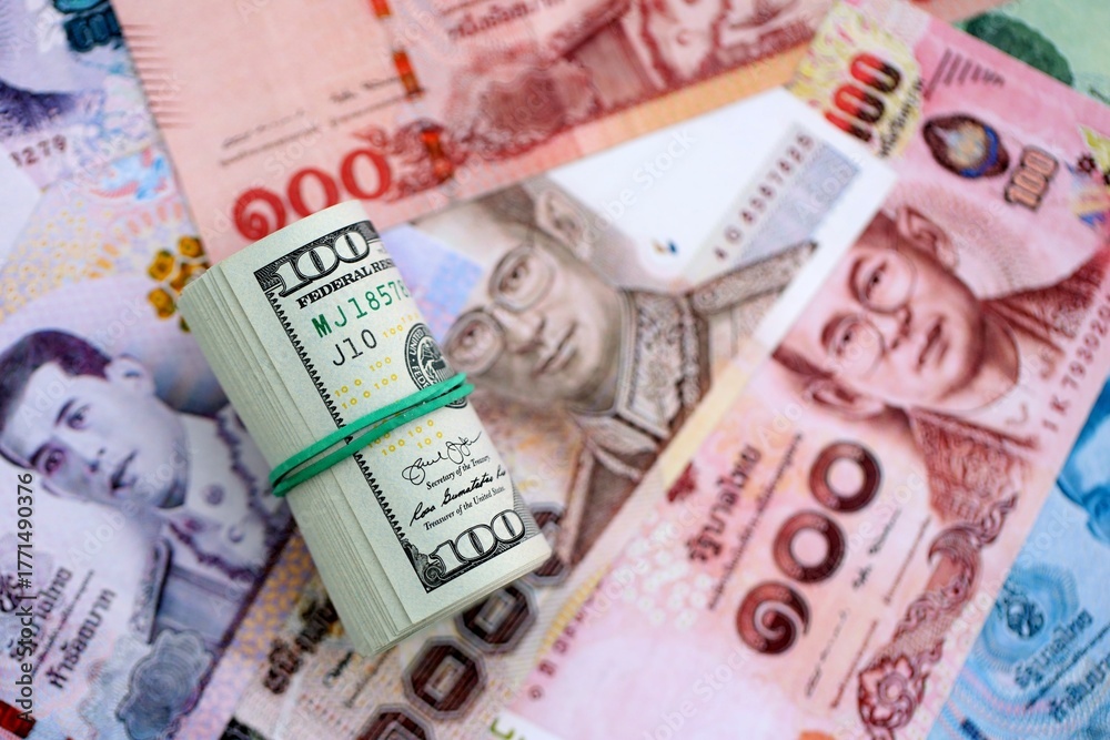 Thai baht currency money bills and bunch of us dollar banknotes close ...