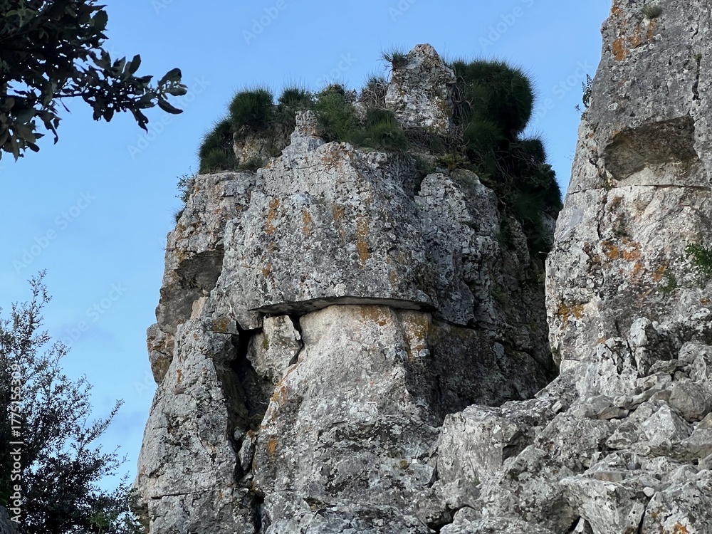 Limestone rocks and karst formations on mountain peaks along Lake Vrana ...