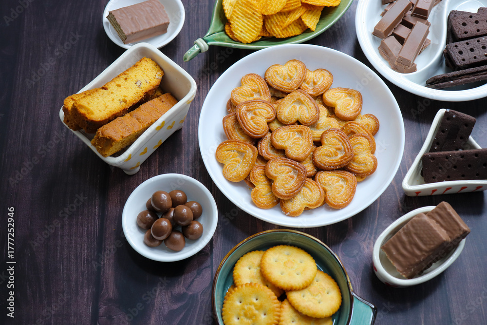 Assorted party snacks on table featuring chocolate cream sandwich ...