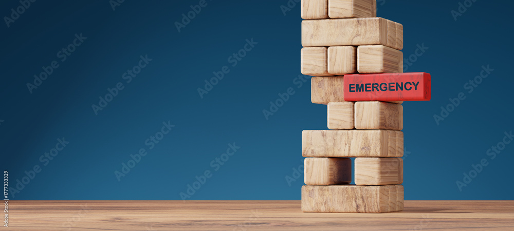 Stack of wooden blocks with one red block labeled EMERGENCY ...