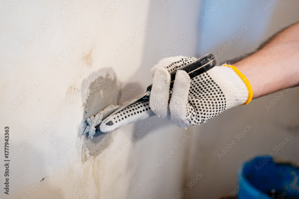 Demonstrating the skilled trade of wall repair, showing the application ...