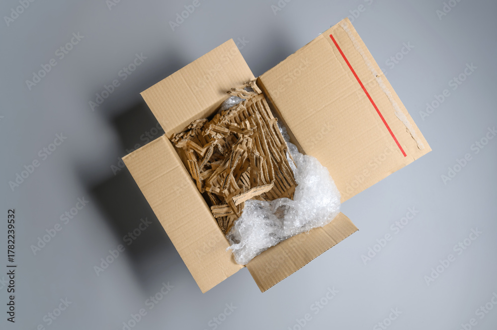 Crushed shredded corrugated cardboard filling materials inside opened ...