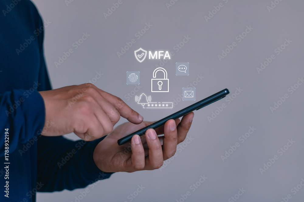 Close-up of a person using a smartphone with MFA security icons ...