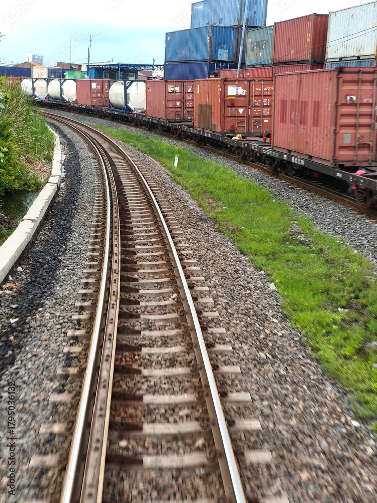 Freight train hauling shipping containers and tank wagons on a curved ...