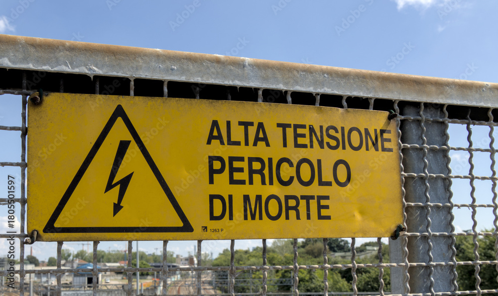 alta tensione pericolo di morte sign above train tracks in Milan Italy ...