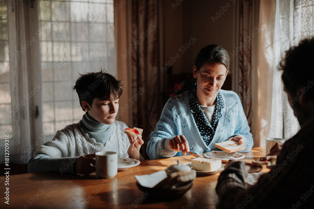 Family having simple meal together, eating bread with jam. Stock Photo ...