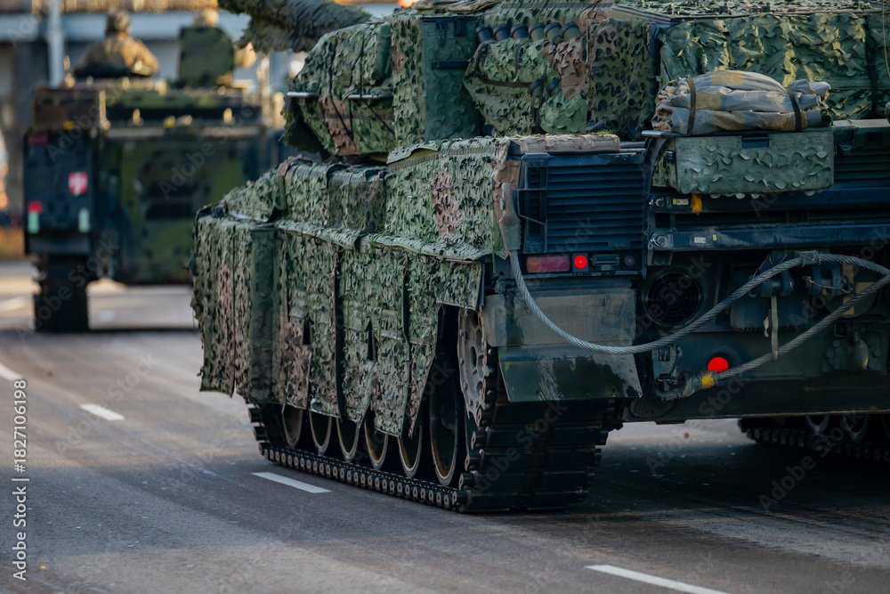 Heavily camouflaged NATO tanks advancing together, illustrating ...