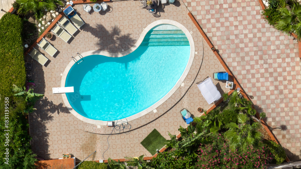 Aerial perpendicular view of a circular swimming pool on a beautiful ...