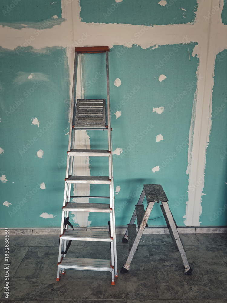 Two Aluminum Ladders Positioned in Front of a Partially Finished ...