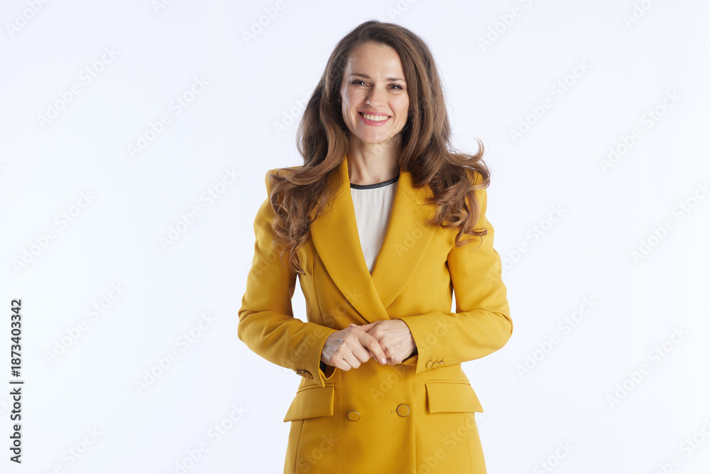 A friendly and confident businesswoman in a bright yellow blazer smiles ...