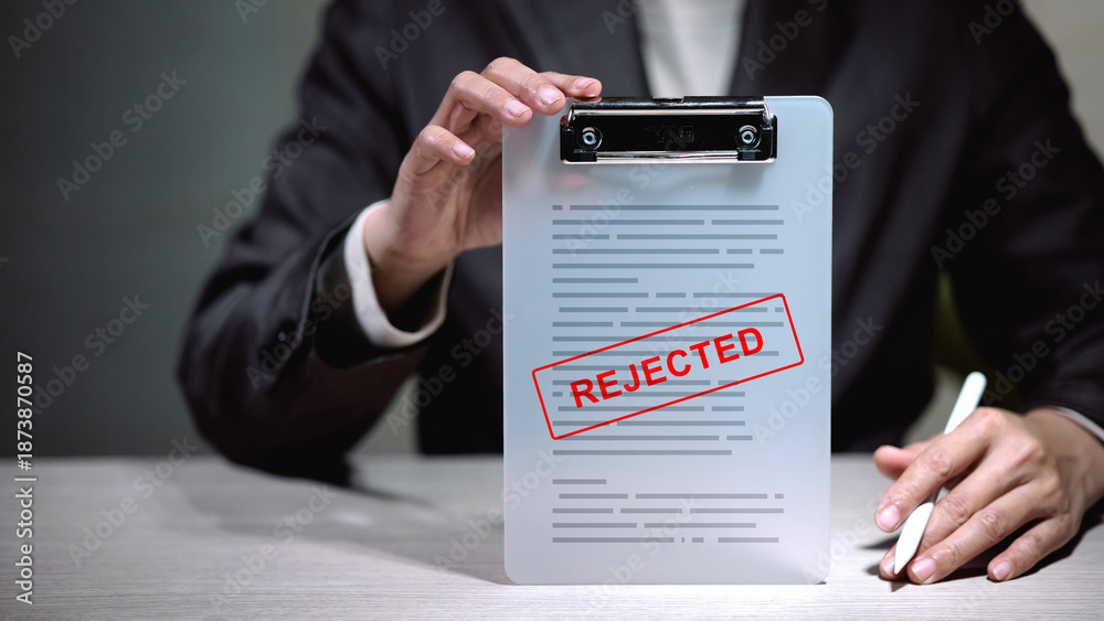 Document rejected concept with businessman holding clipboard and red ...