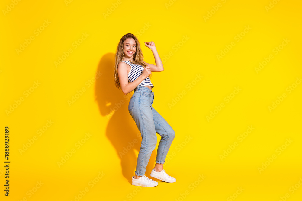 Стоковое фото «Smiling young girl poses joyfully against a vibrant ...