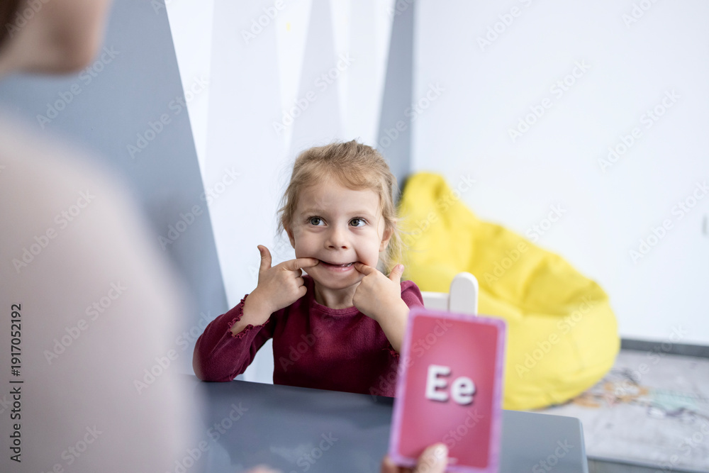 Young girl learning pronunciation with speech therapist, making mouth ...
