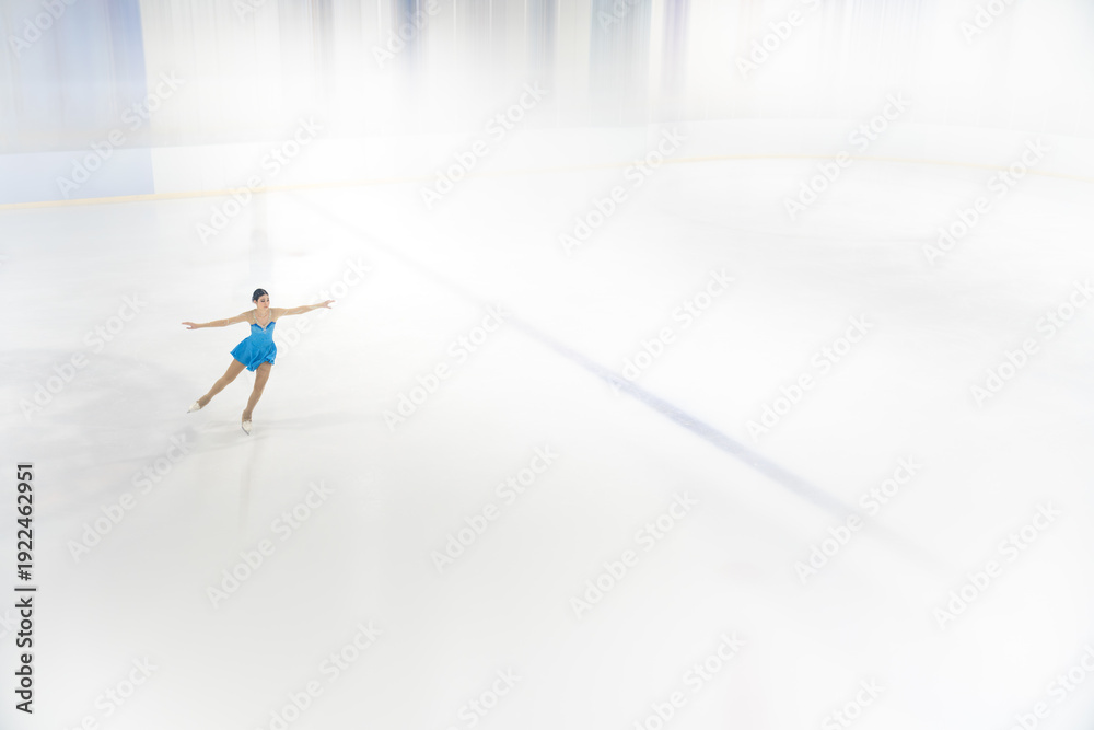 Graceful ice skater performing a spin on an empty ice rink Stock Photo ...
