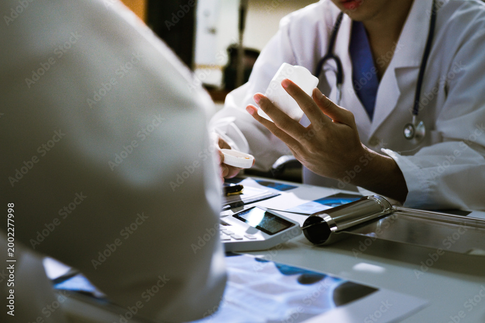 Doctor Explaining X-Ray Results to a Patient Using a Digital Device ...