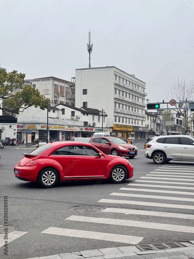 Suzhou, China, 1 April 2026 ? A red Volkswagen Beetle crosses a busy ...