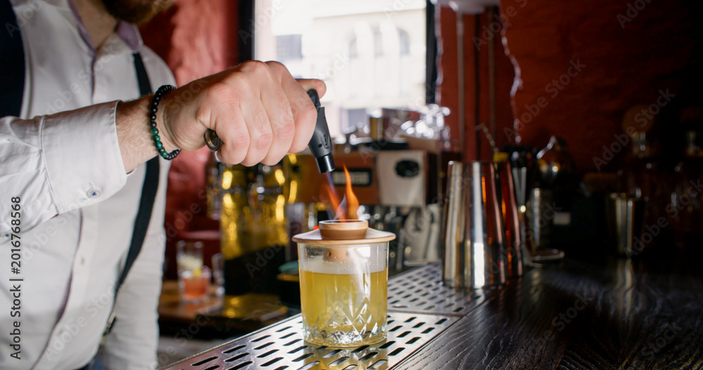 Flaming cocktail. Fresh alcohol drink. Unrecognizable bartender man ...
