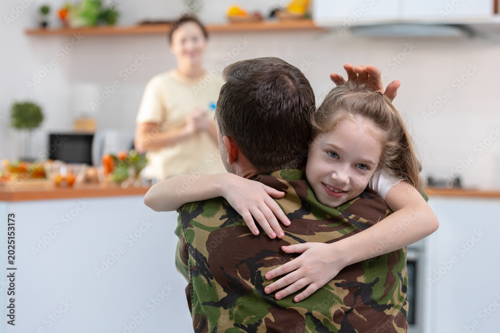 Happy soldier father sharing joyful hug with his young daughter during ...