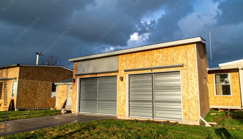 Reinforced steel roller shutters secured over garage doors and windows ...