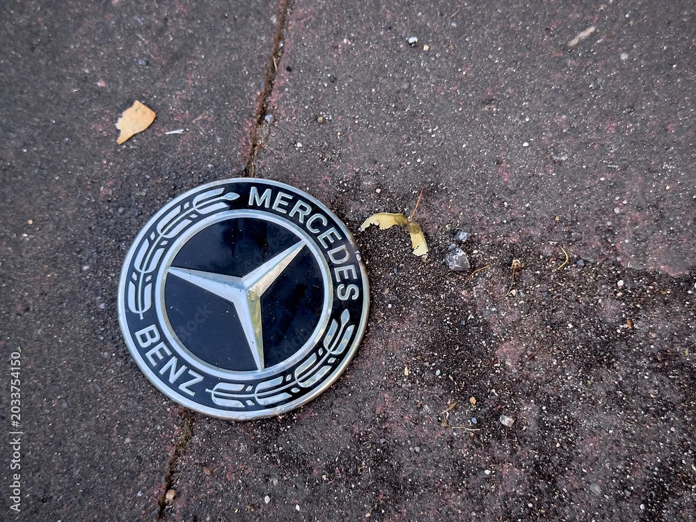 Cologne, Germany - 24 May, 2026: A Mercedes-Benz emblem is seen lying ...
