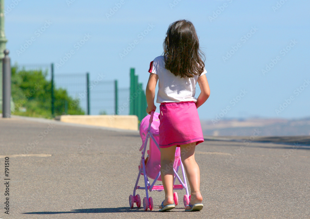 Petite fille et sa poussette Stock Photo | Adobe Stock
