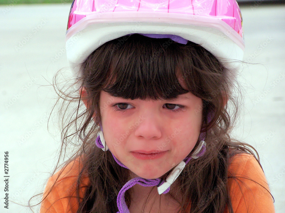 child crying while wearing a bike helmet Stock Photo | Adobe Stock