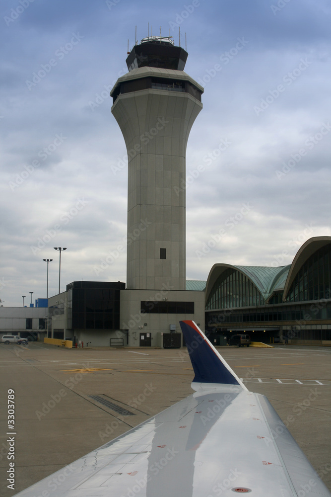 air traffic control tower with the wing of the plane Stock Photo ...