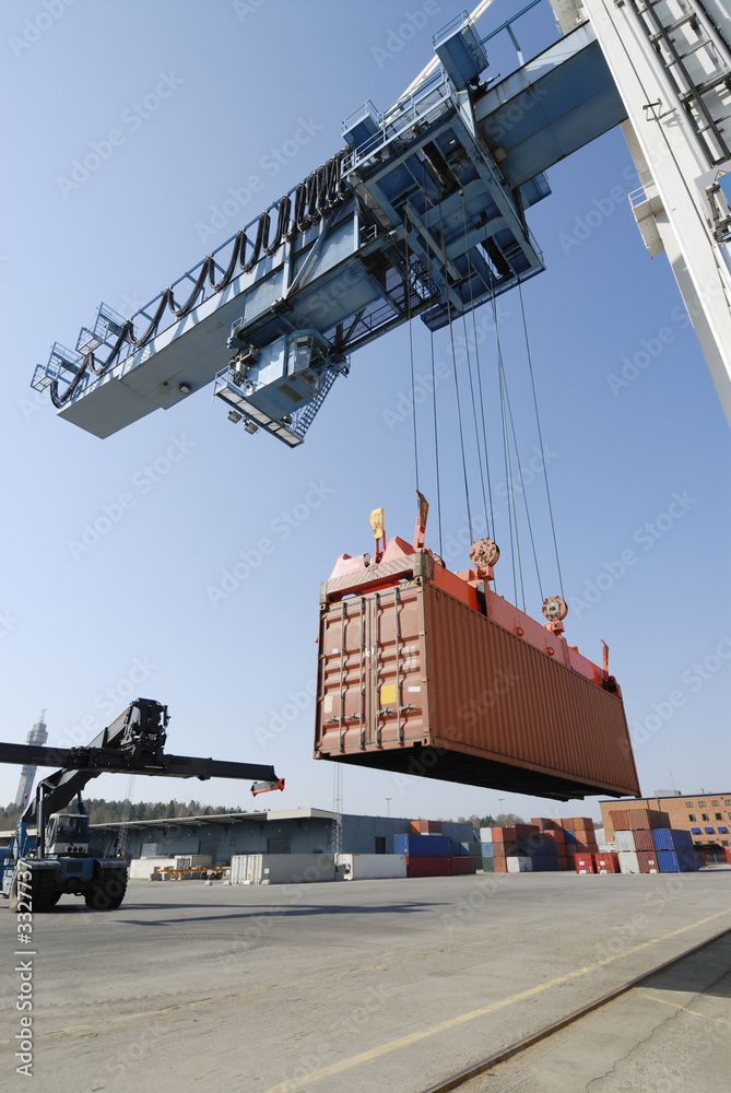 crane lowering container to forklift Stock Photo | Adobe Stock