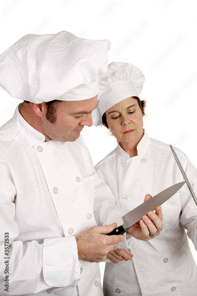 A chef testing the sharpness of his knife blade Stock 写真 | Adobe Stock