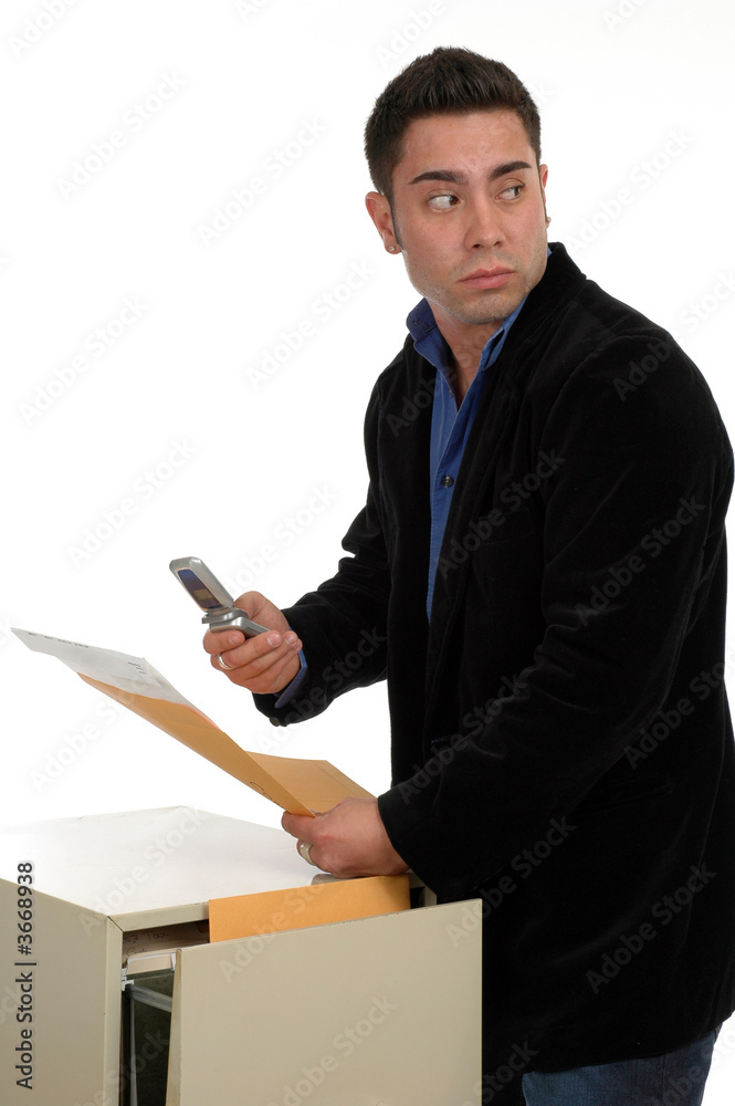 A man slipping documents out of a file cabinet a Stock Photo | Adobe Stock