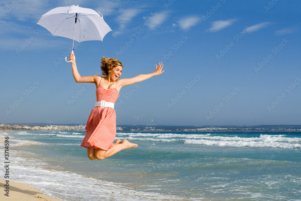 happy person jumping for joy on beach summer vacation Stock Photo ...