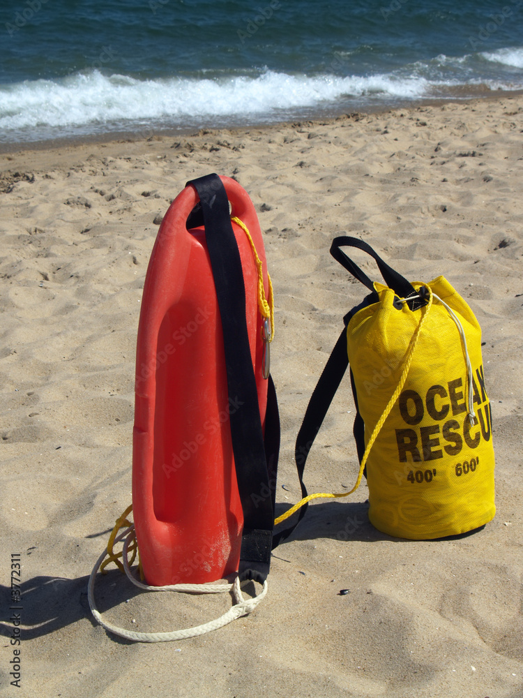 Ocean Rescue Gear in Sand-- Patrol Rescue Can and Rope Bag Stock Photo ...