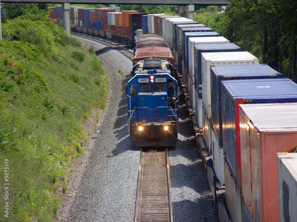 Locomotive pulling short train beside parked container cars Stock Photo ...