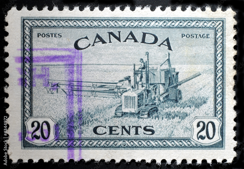 Wheat harvest and 1930s style combine on old Canada stamp Stock Photo ...