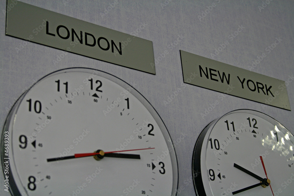 two clocks on the wall with different time zones Stock Photo | Adobe Stock