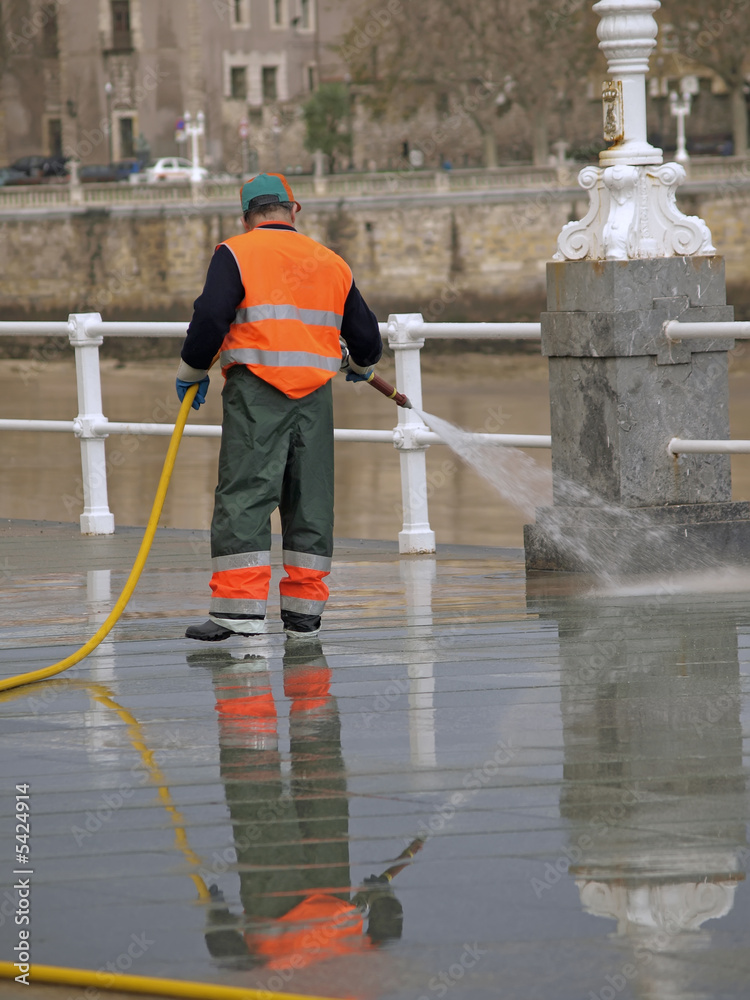 Hombre regando la calle Stock Photo | Adobe Stock