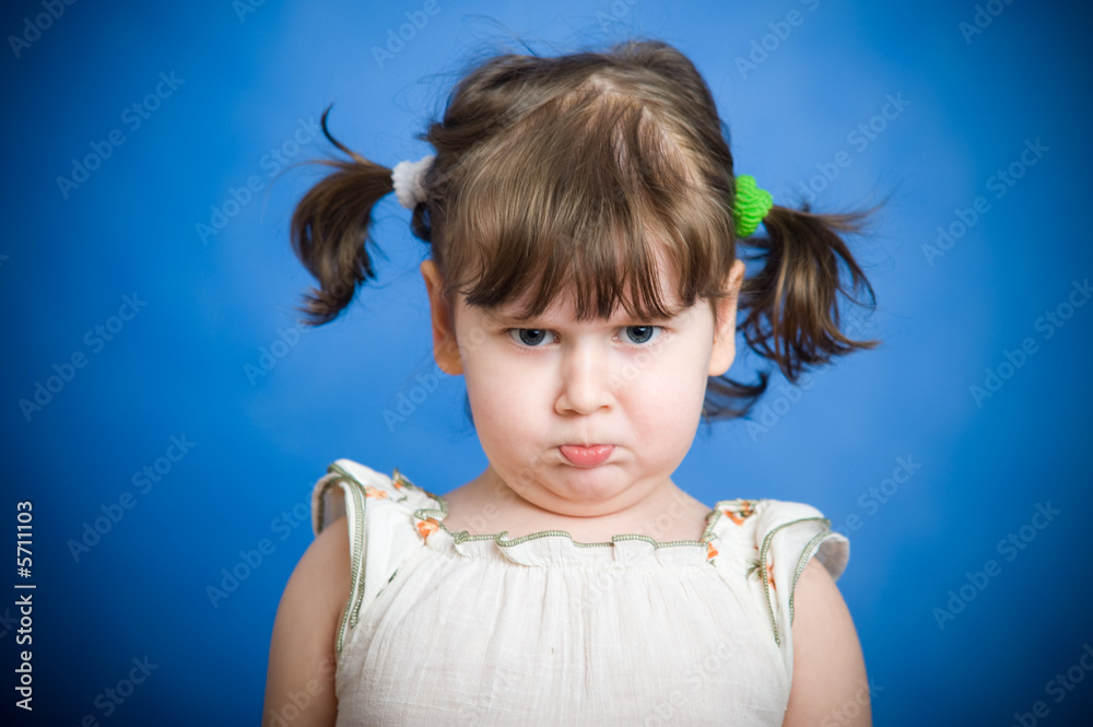 Angry kid on blue background Stock Photo | Adobe Stock