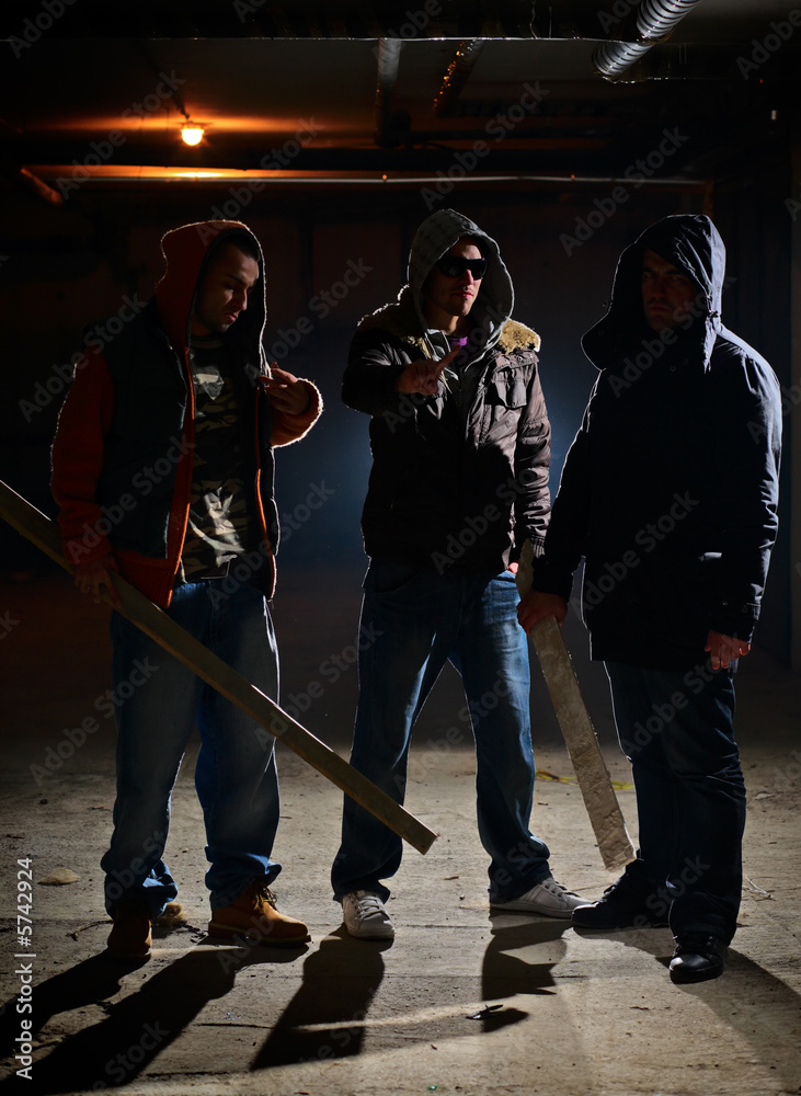 Gang members in a dark alley Stock Photo | Adobe Stock