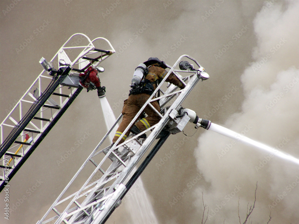 Fireman and hoses on ladders battling ferocious fire Stock Photo ...