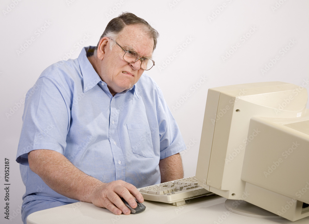 Old Guy at computer grimacing Stock Photo | Adobe Stock
