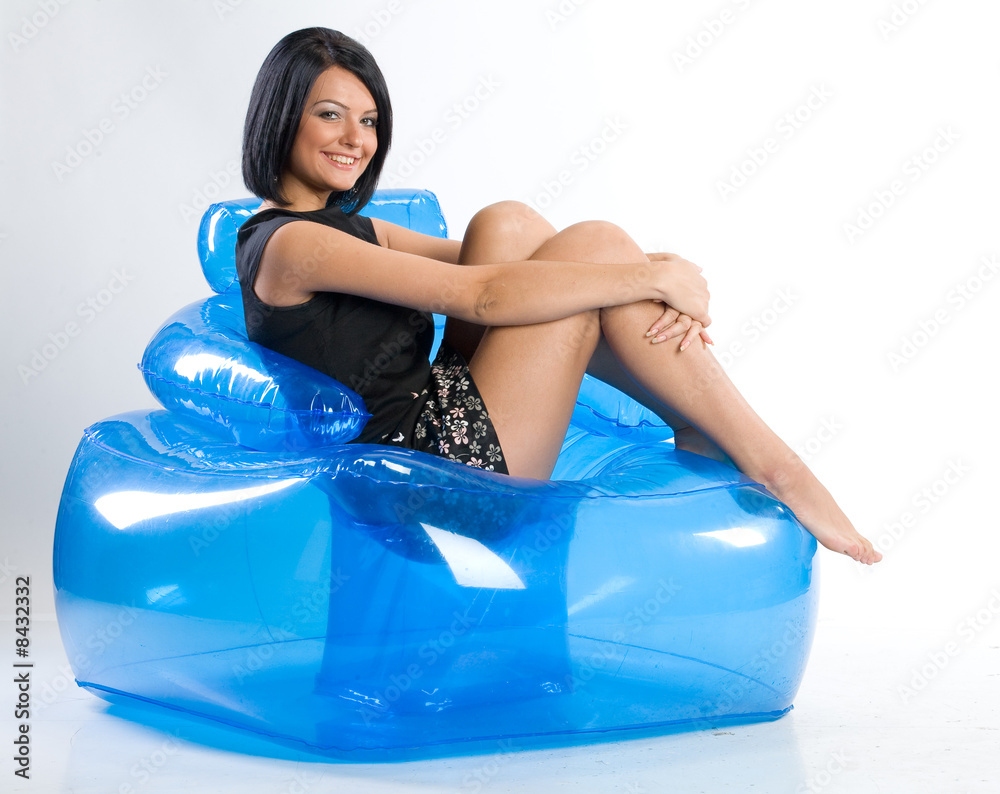 Young Woman In Blue Inflatable Armchair Stock Photo | Adobe Stock