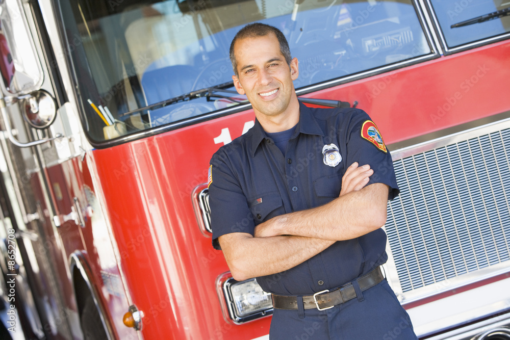 Portrait of a firefighter by a fire engine Stock 写真 | Adobe Stock