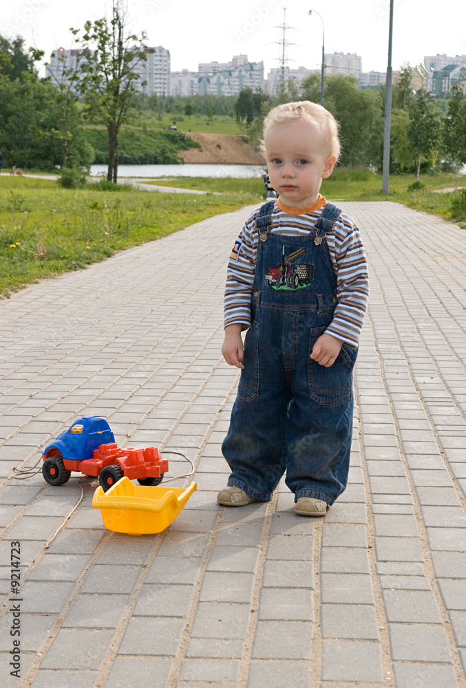 Sad boy with a broken toy truck Stock Photo | Adobe Stock