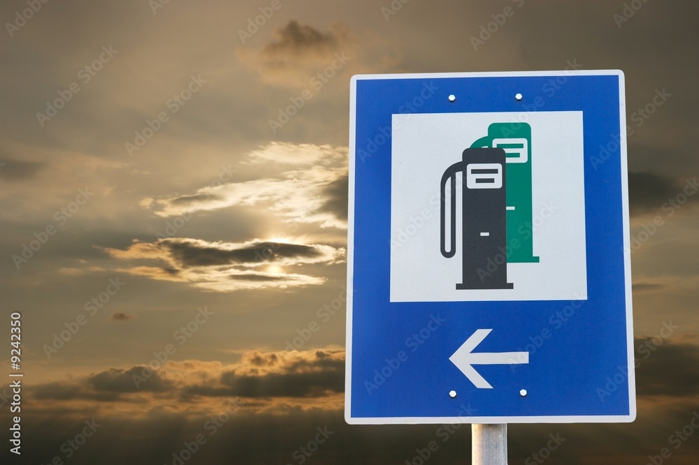 Petrol station sign against dark sunset sky Stock Photo | Adobe Stock