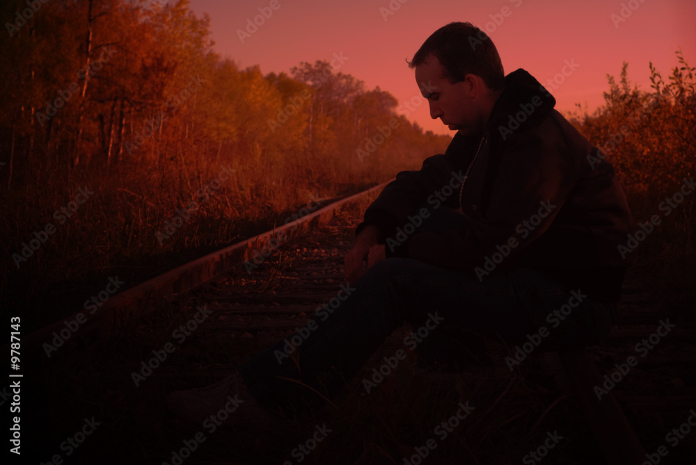 Depressed man sitting on train tracks, perfect for a dark mood Stock ...