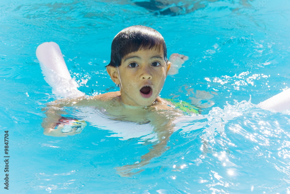 Boy having fun in swimming pool . Stock Photo | Adobe Stock