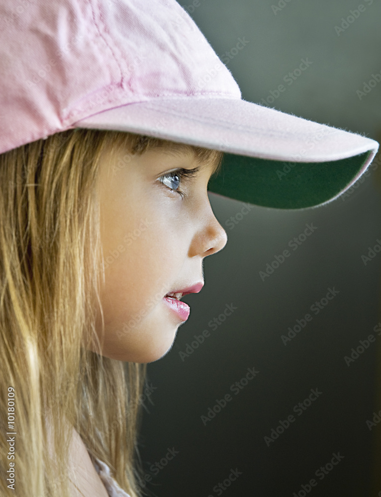 side view portrait of a little girl, model in pink cap Stock Photo ...