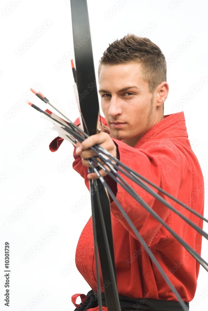 Young archer concentrating and aiming at the camera, isolated Stock ...