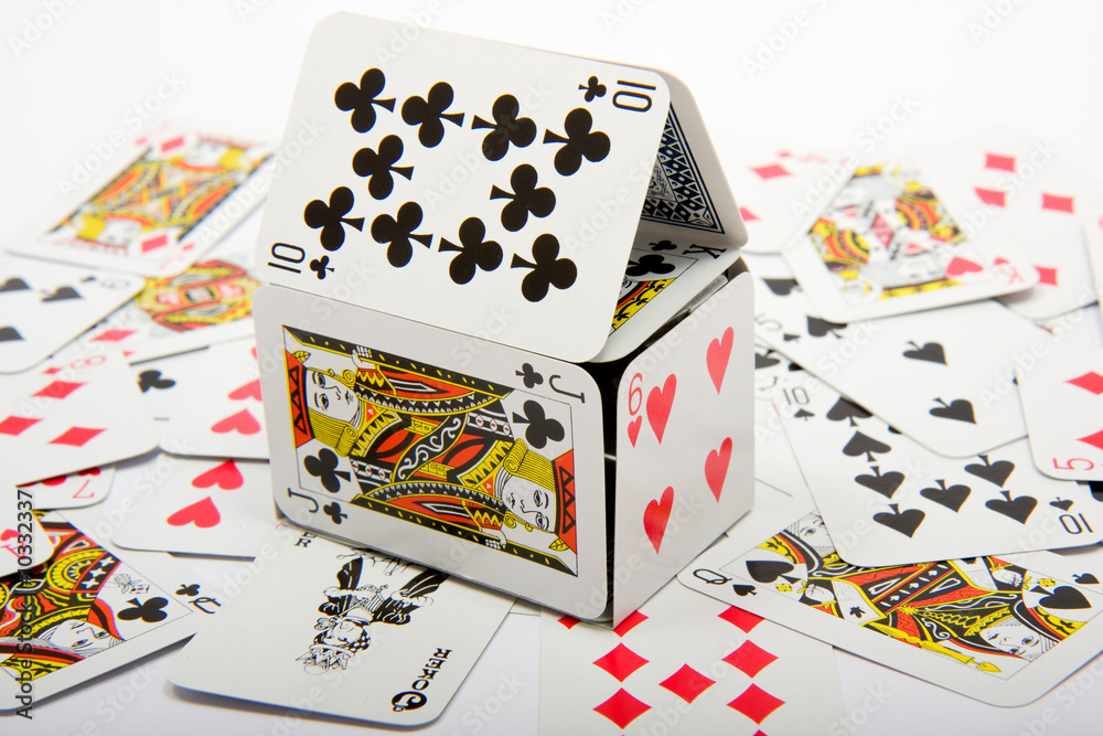 A house made of playing cards sitting on top of other cards Stock Photo ...