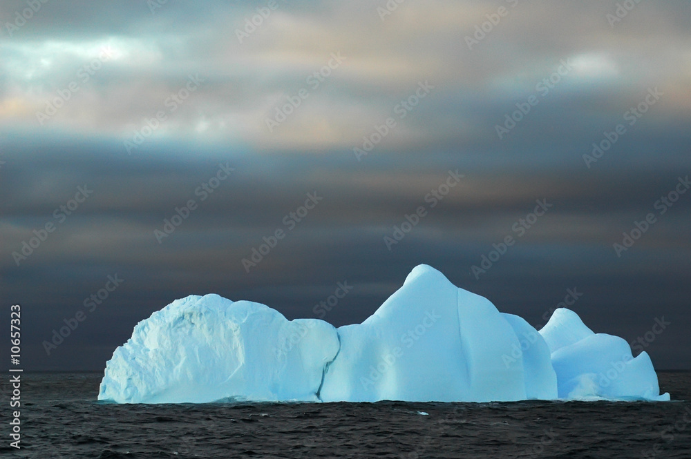 Blue iceberg with dark sky Stock Photo | Adobe Stock